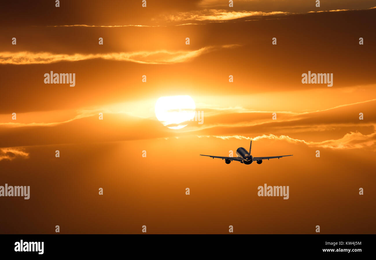Plane is taking off at sunset Stock Photo - Alamy