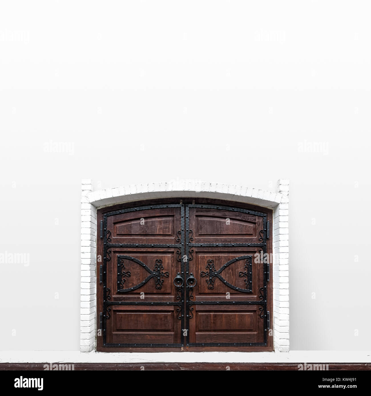 Old wooden gate in a white wall Stock Photo - Alamy