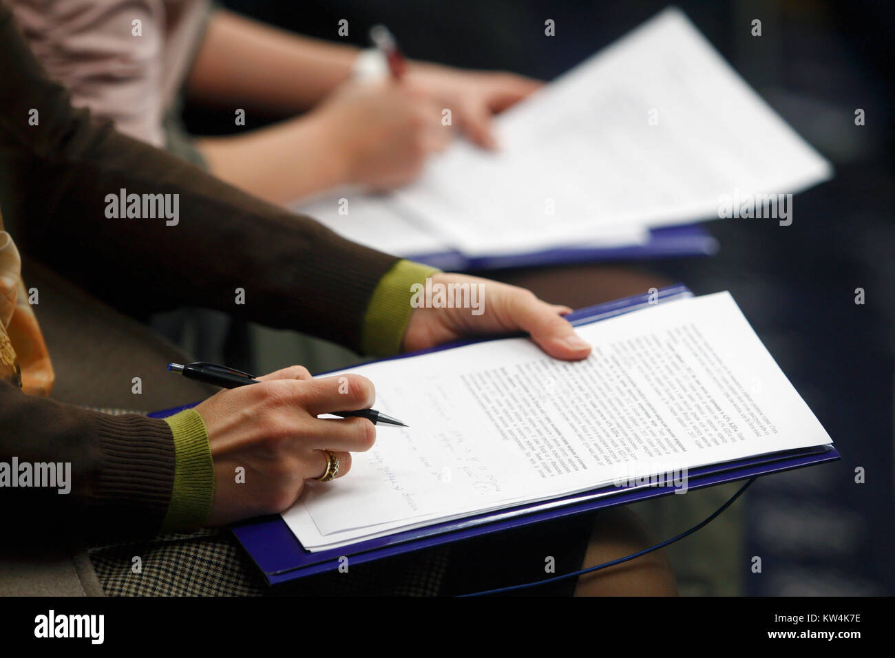 Journalist is reading press material during a conference Stock Photo ...