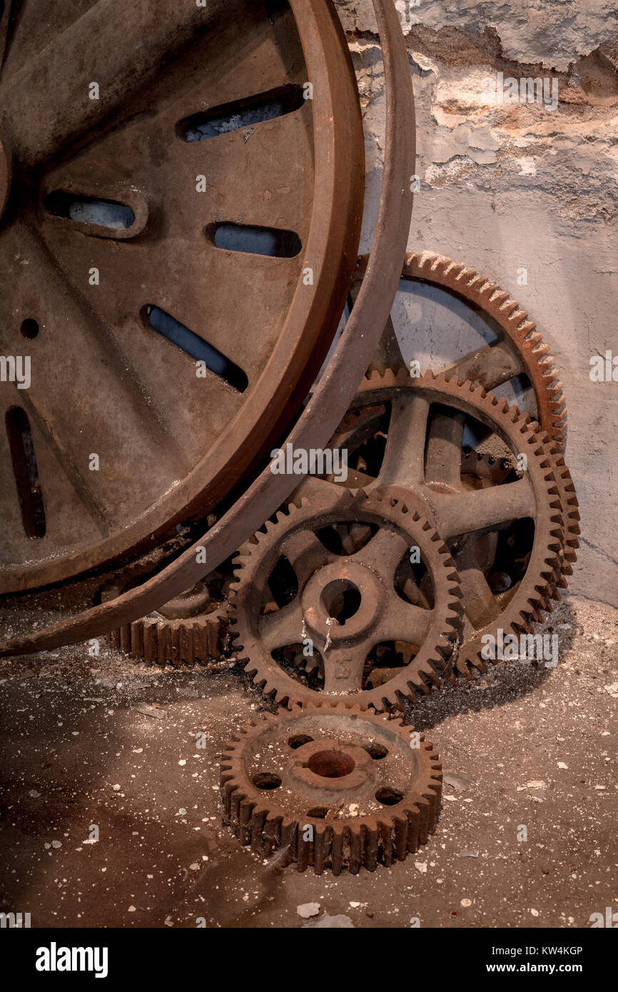 Old gears in a shop leaning against a wall Stock Photo - Alamy