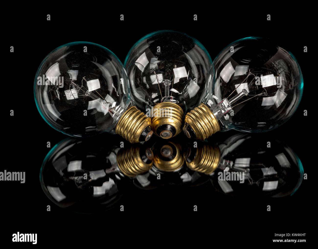Highly reflective glass light bulbs on a black surface Stock Photo - Alamy