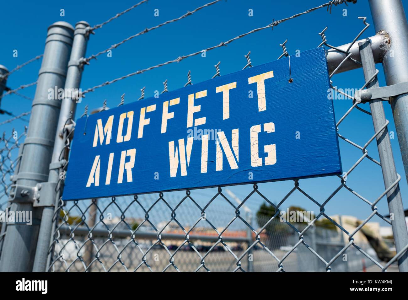 Blue and white stenciled sign for the Moffett Air Wing hanging on a ...