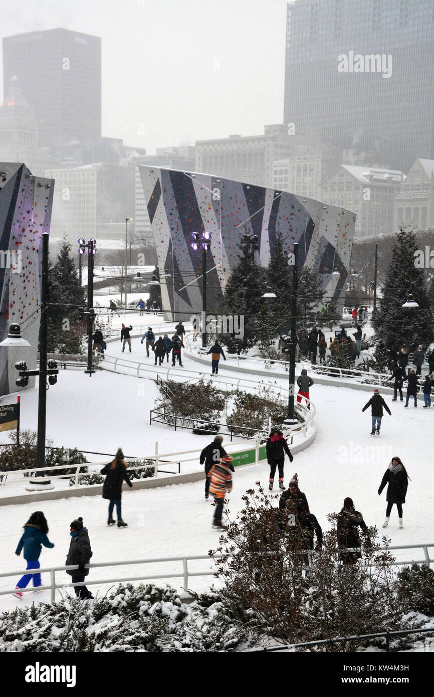 Visitors enjoy outdoor ice skating in the snow at the quarter mile long ...