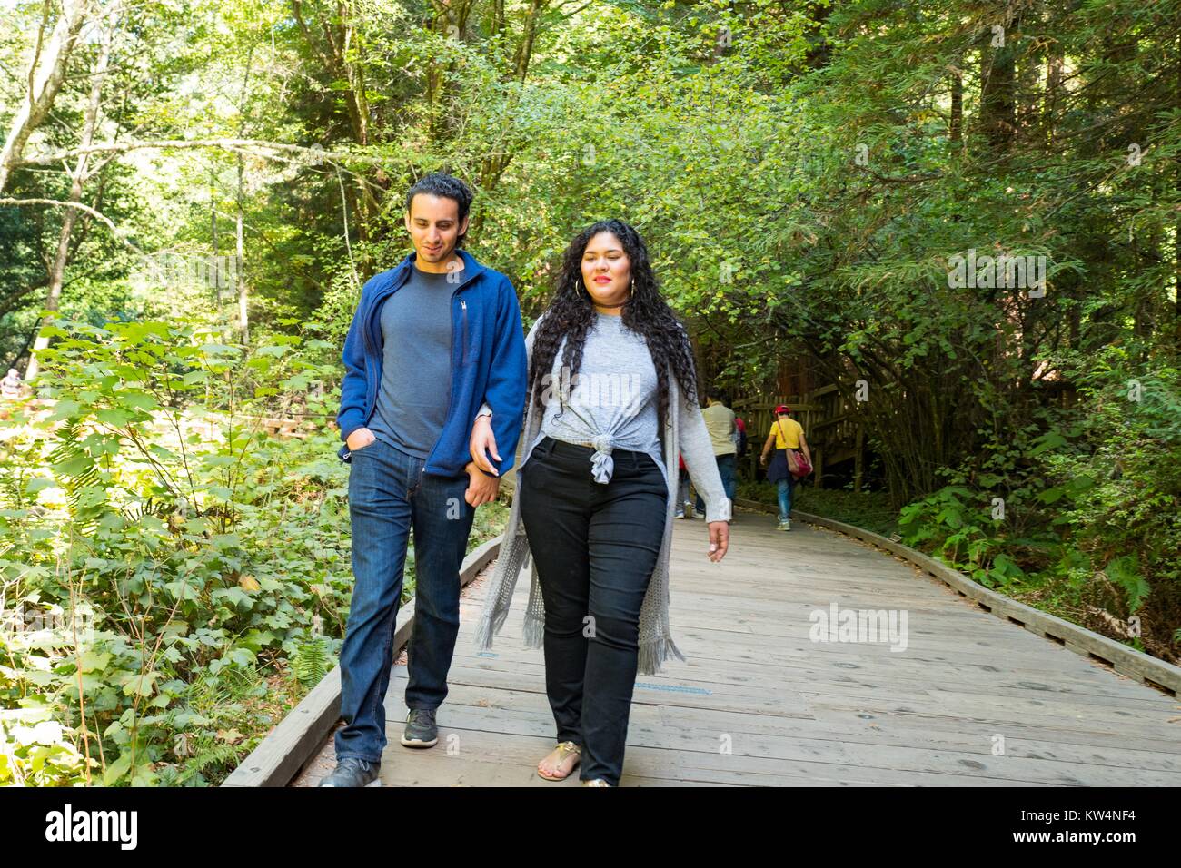 Walking arm in arm hi-res stock photography and images - Alamy
