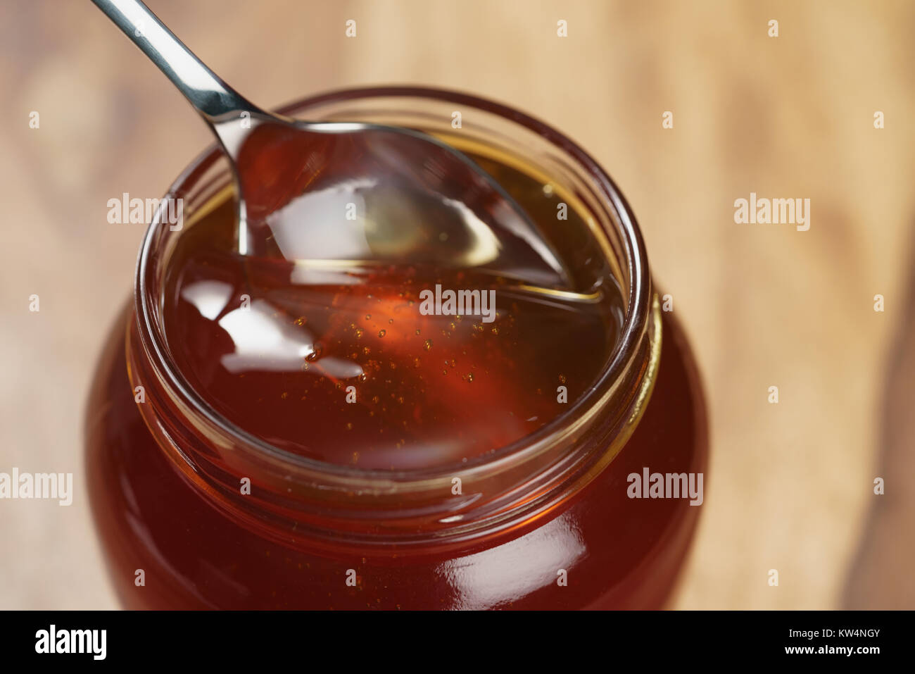 scooping organic honey with spoon from glass jar, shallow focus Stock ...