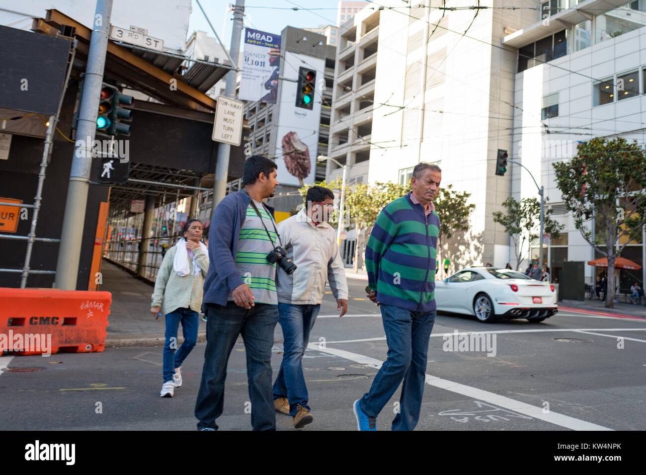 A family crosses a street at a designated crosswalk, San Francisco ...