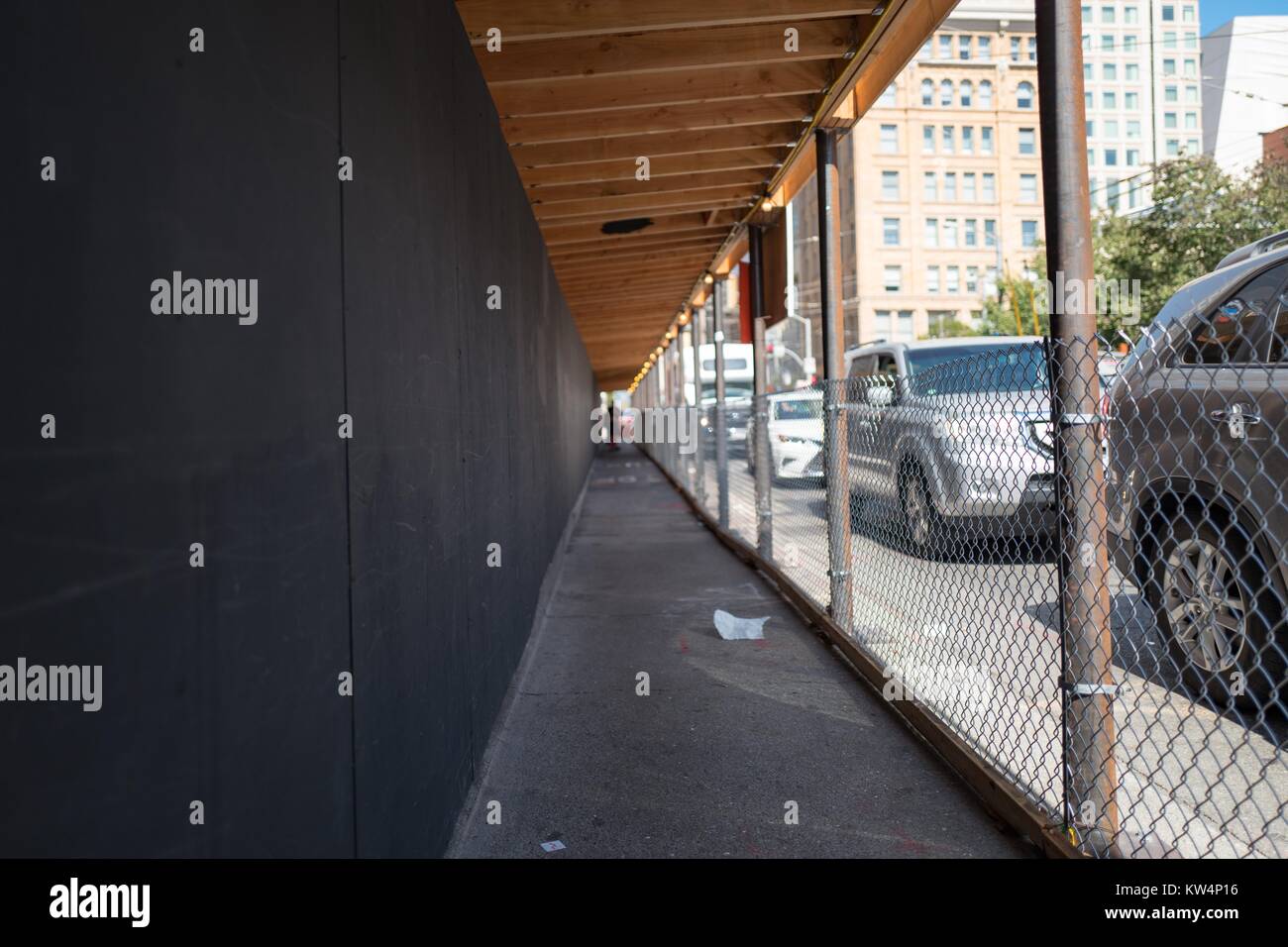 A covered walkway protects pedestrians traveling through an active ...