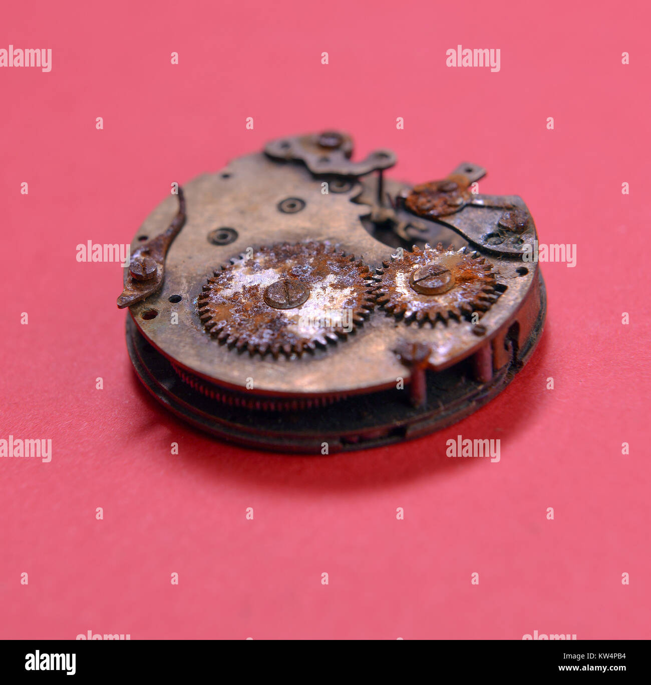 rusty old clock mechanism on red background,image of a Stock Photo - Alamy