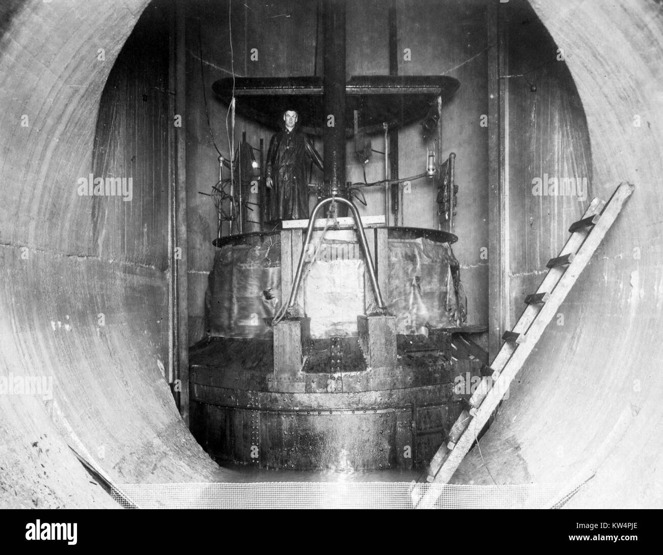 A worker stands atop a piece of machinery during construction of the ...