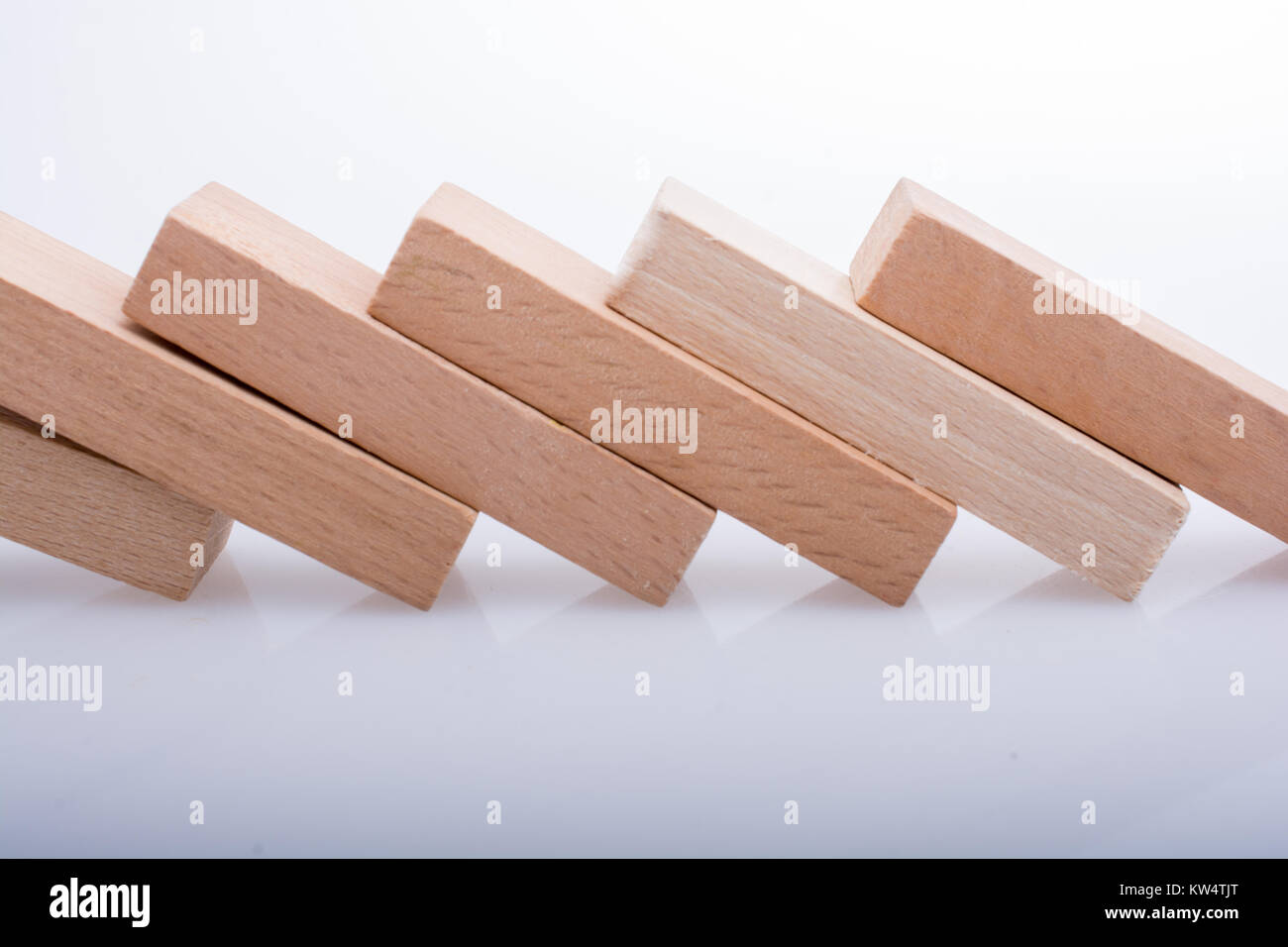 Wooden Domino Blocks in a line on a white background Stock Photo - Alamy