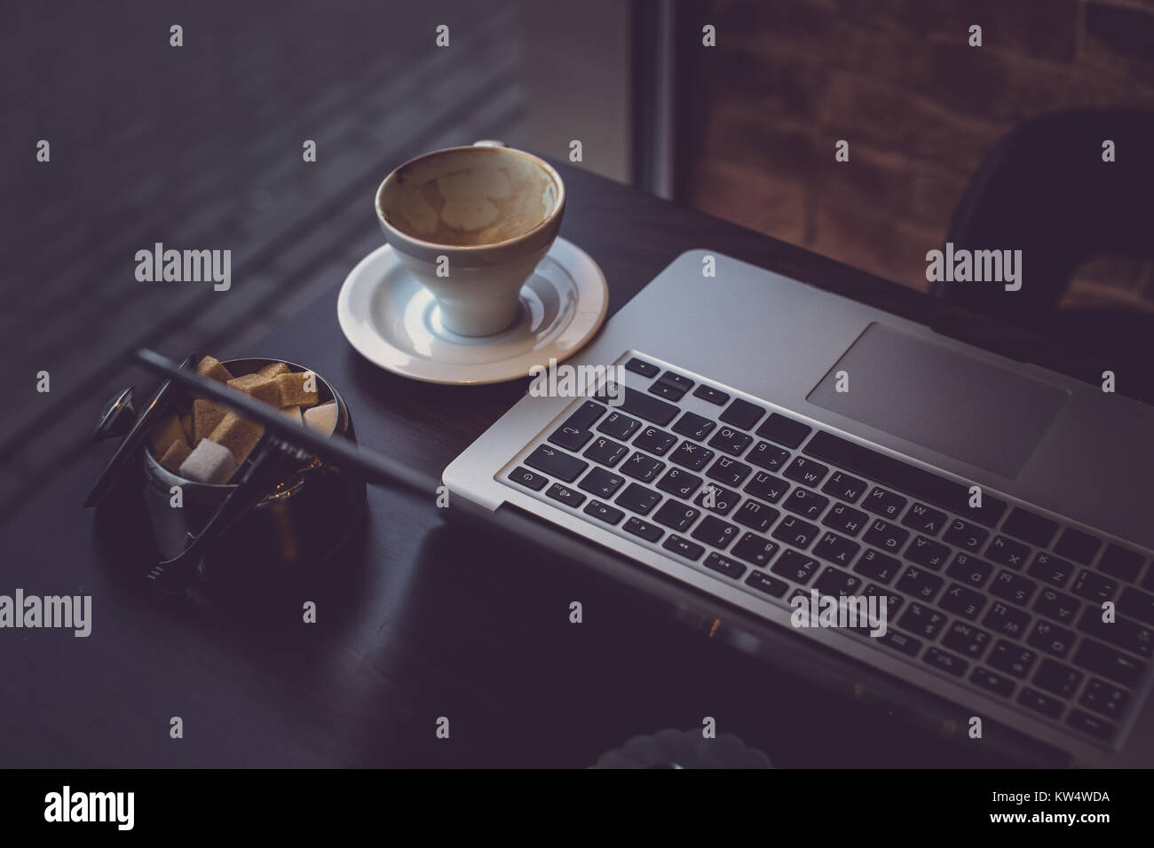 A laptop's keyboard and a cup of coffee Stock Photo - Alamy