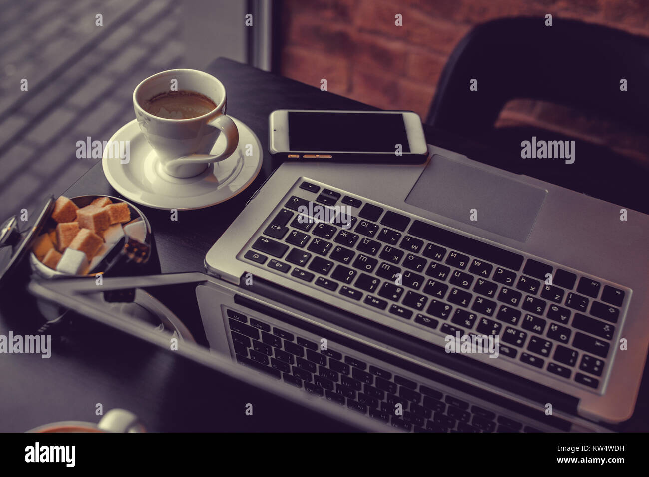 A laptop's keyboard and a cup of coffee Stock Photo - Alamy