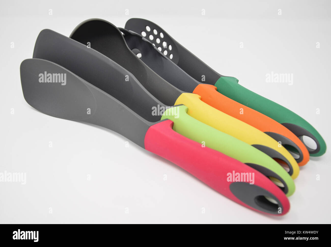 A sey of colourful plastic kitchen utensils including spatula, ladle ...