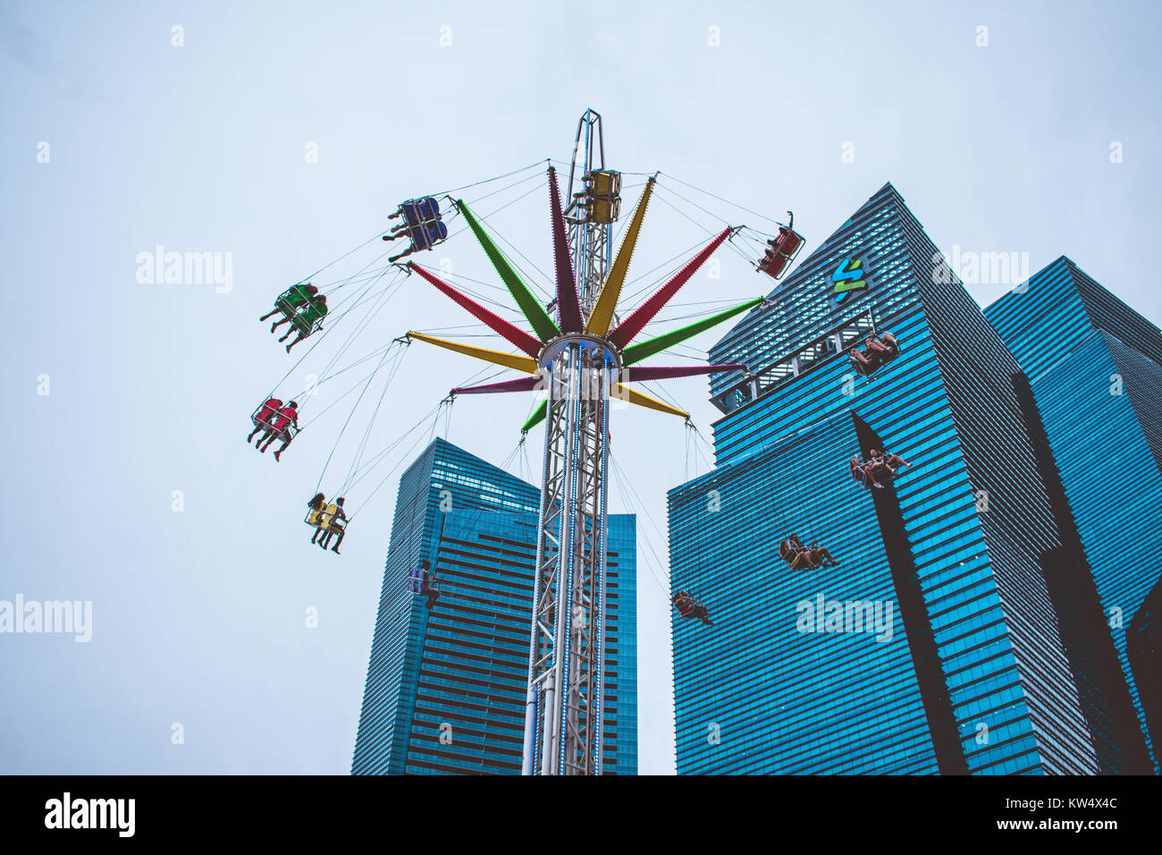 Carnival ride with buildings in the backdrop Stock Photo - Alamy