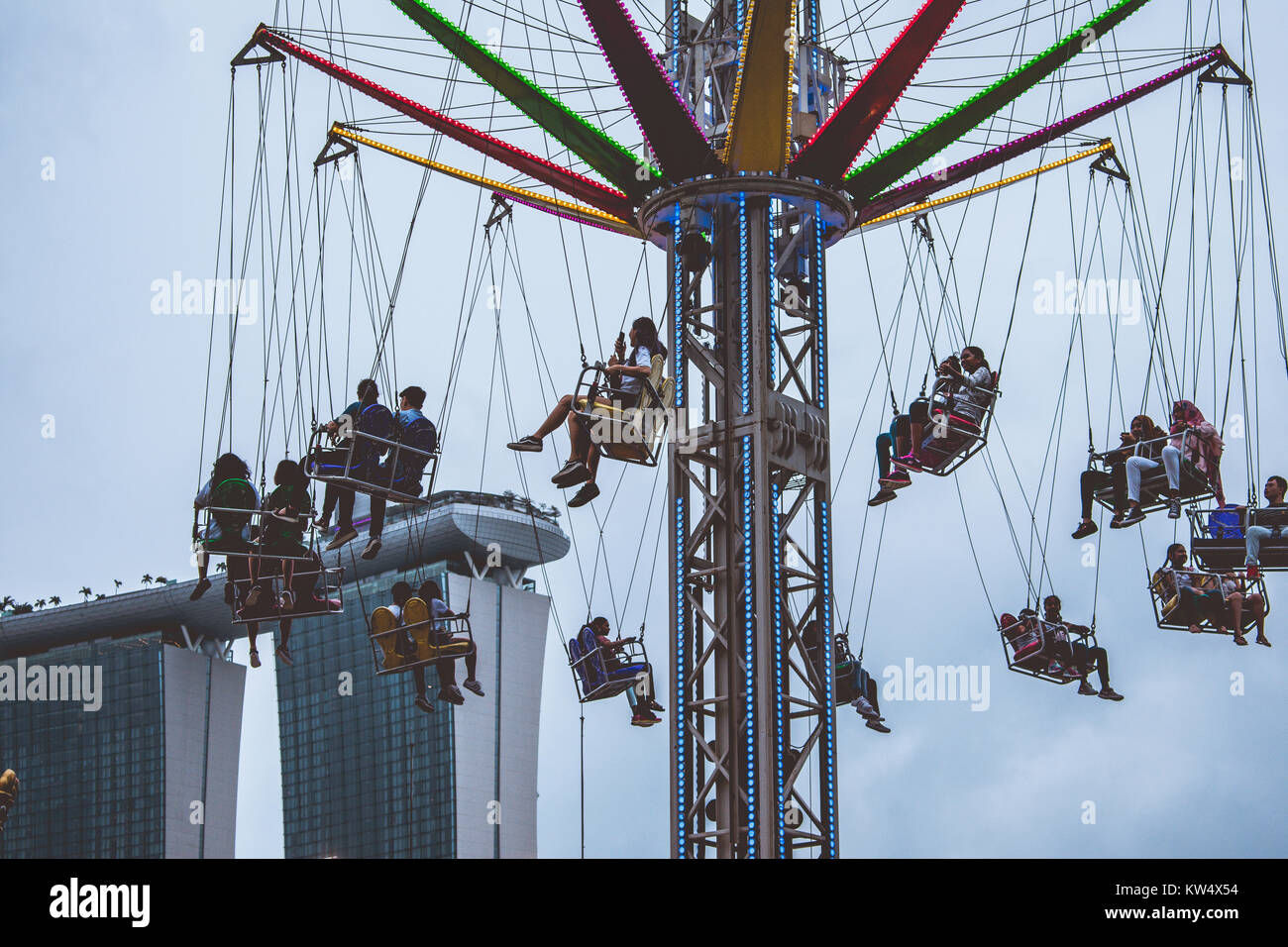 Carnival ride with buildings in the backdrop Stock Photo - Alamy