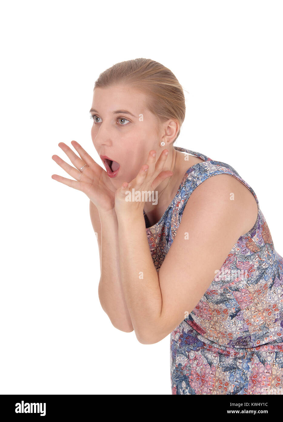 A beautiful woman scared bending forwards with her mouth open and ...