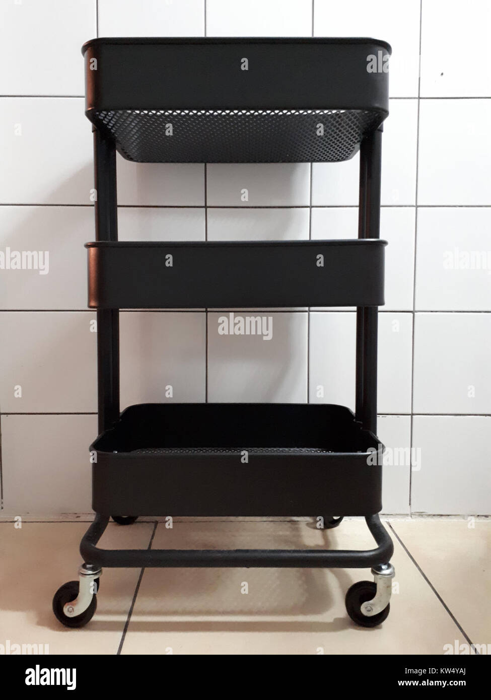 The black metallic rolling cart, designed in 2017, is a versatile piece ...