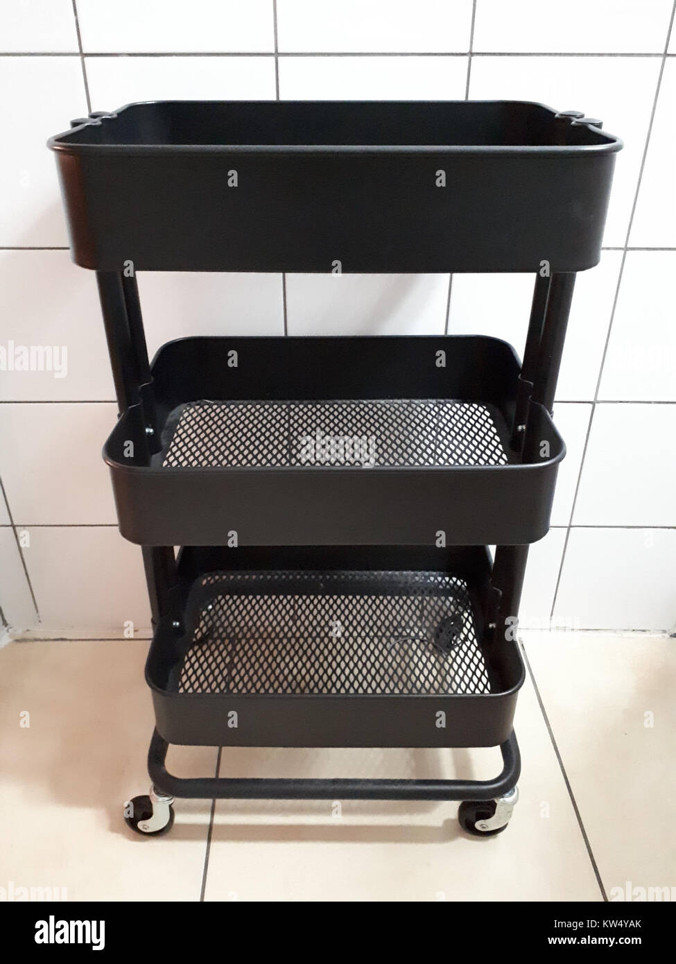 A modern black metallic rolling cart designed for both aesthetic and ...