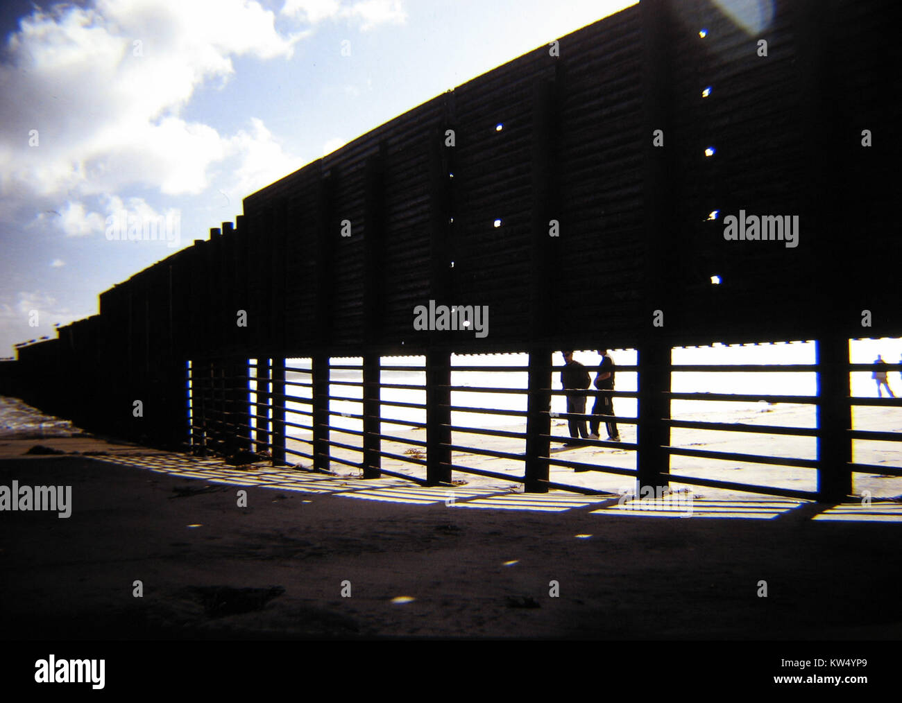 The border fence serves as a physical barrier marking political or ...