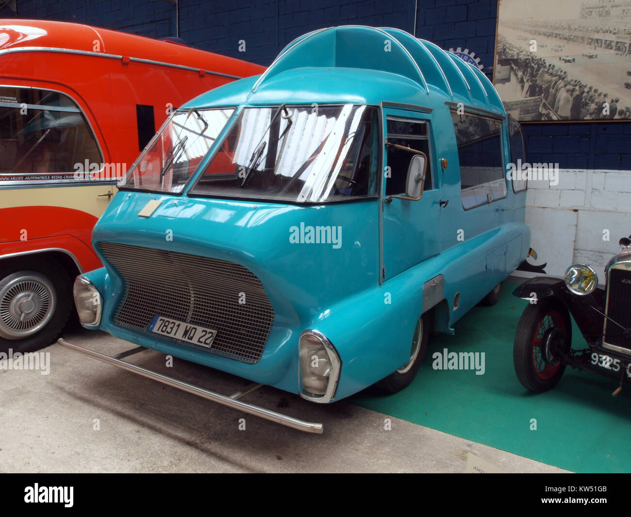 A blue bus on display at the Musée Automobile de Reims, showcasing its ...