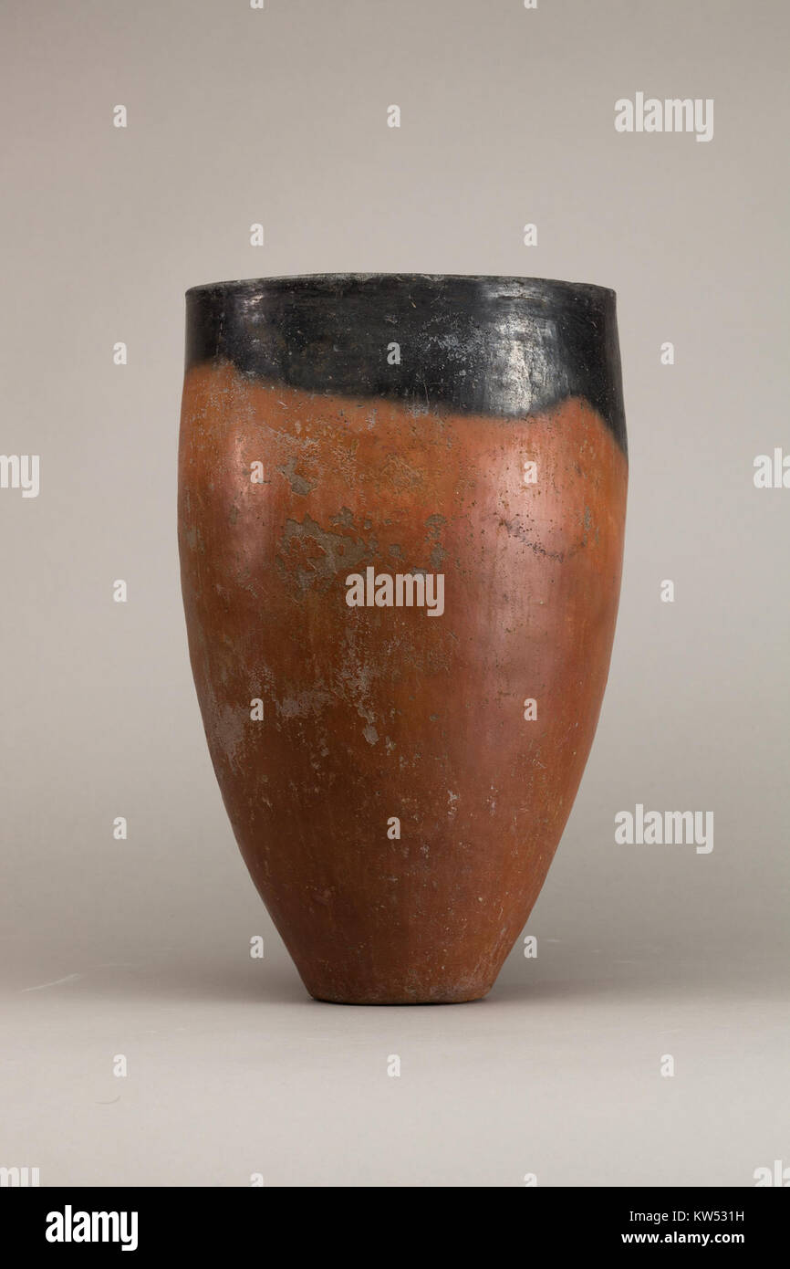 This red ware beaker, with a distinctive black-topped design, is a ...