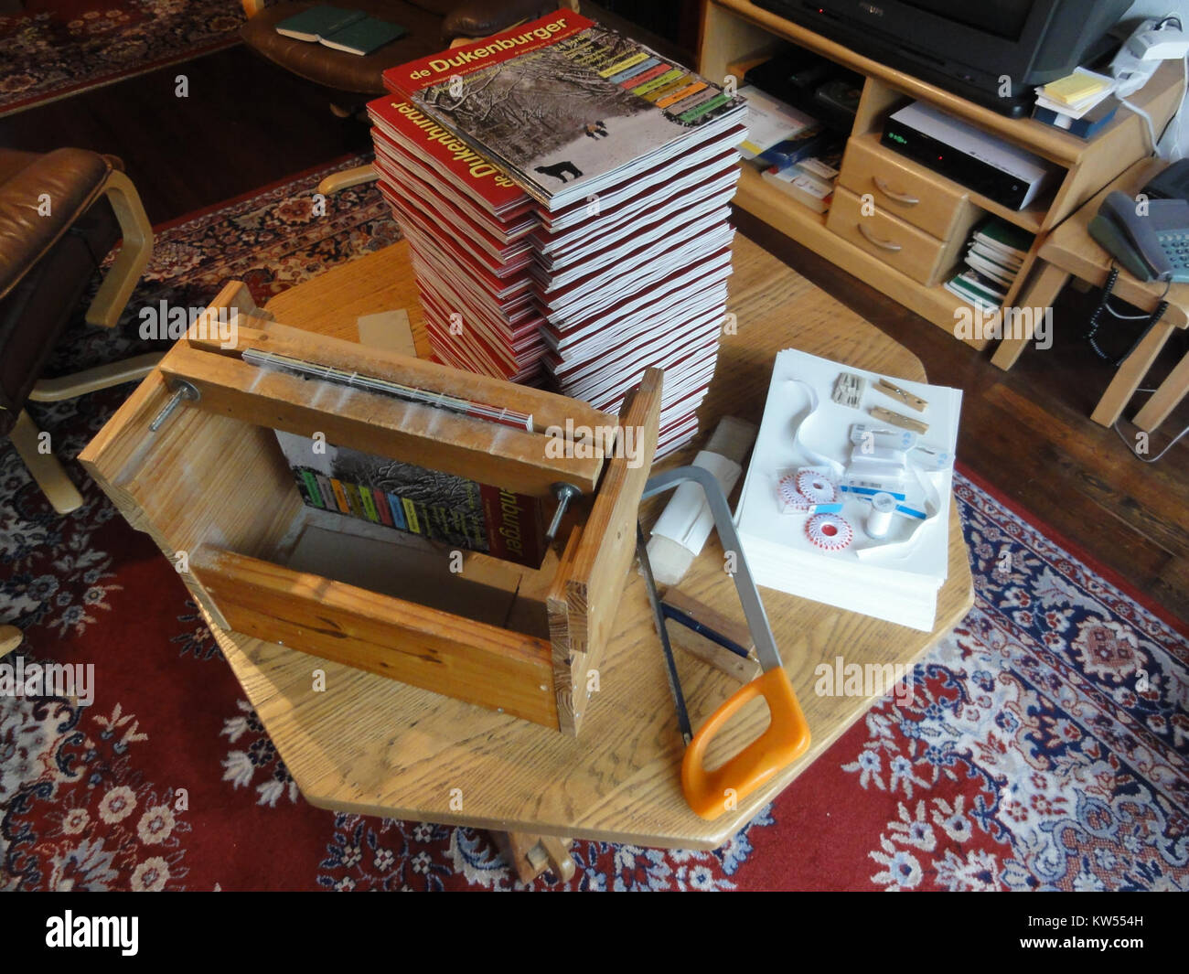 This image captures the art of bookbinding, specifically the technique ...