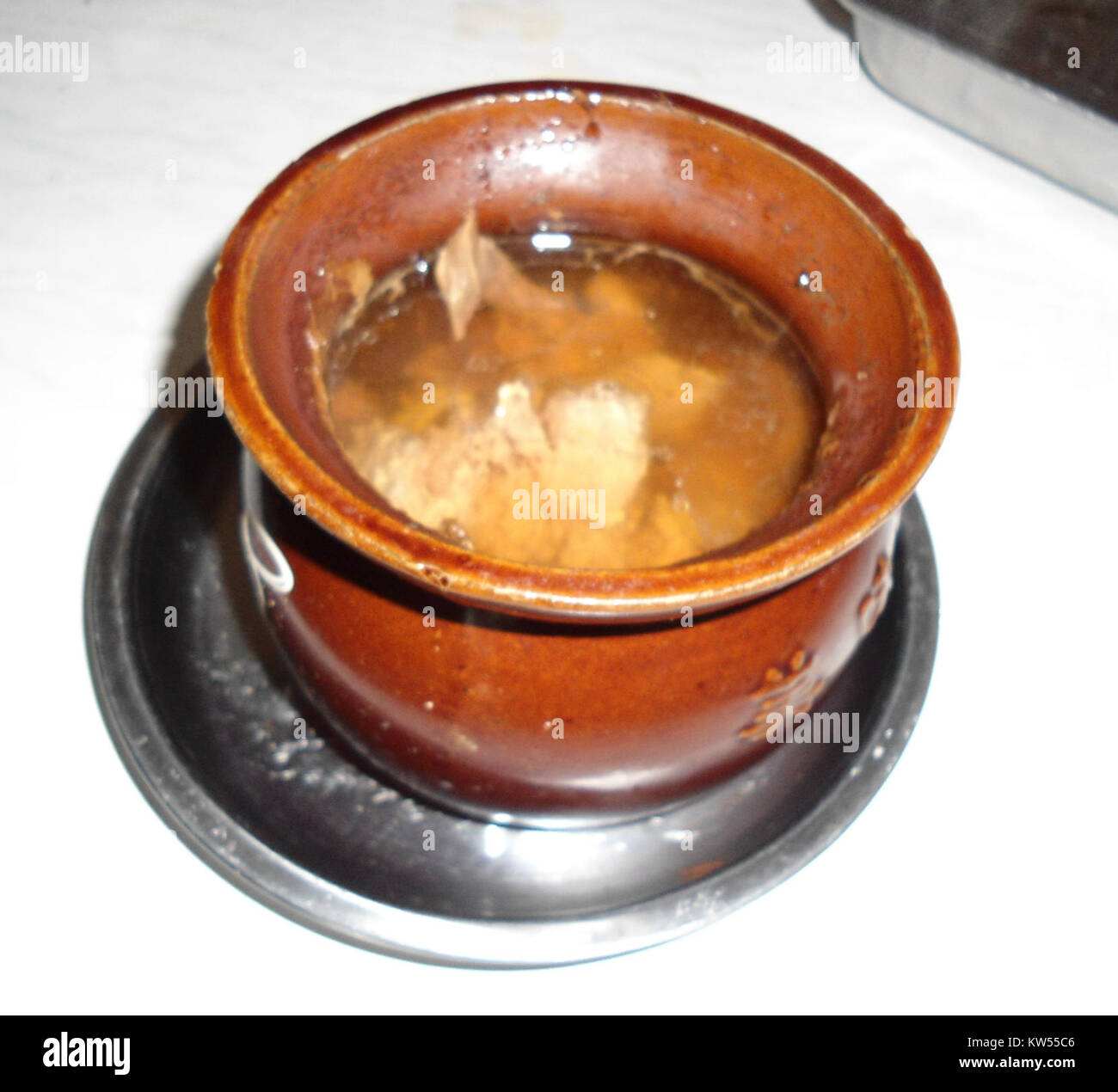 This large pot is designed for soup, featuring a traditional cooking ...