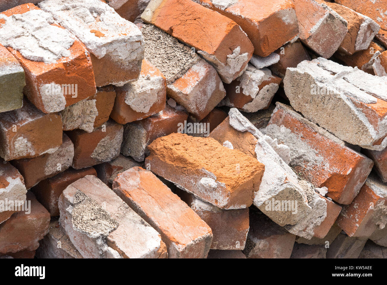 Horizontal closeup of stacks of salvaged bricks with some old mortar ...