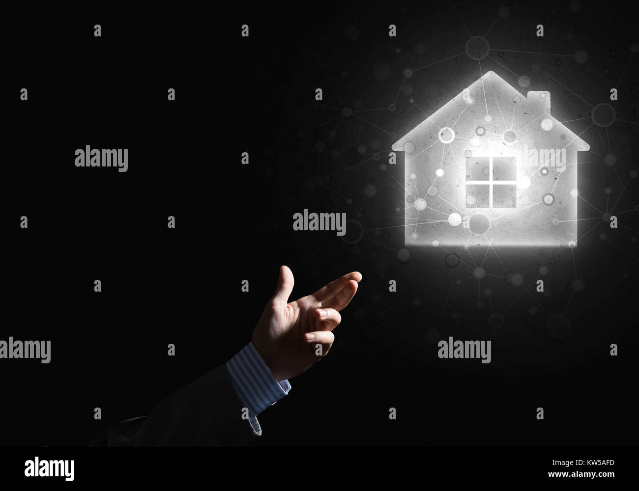 Businessman hand presenting glowing home icon or symbol Stock Photo - Alamy
