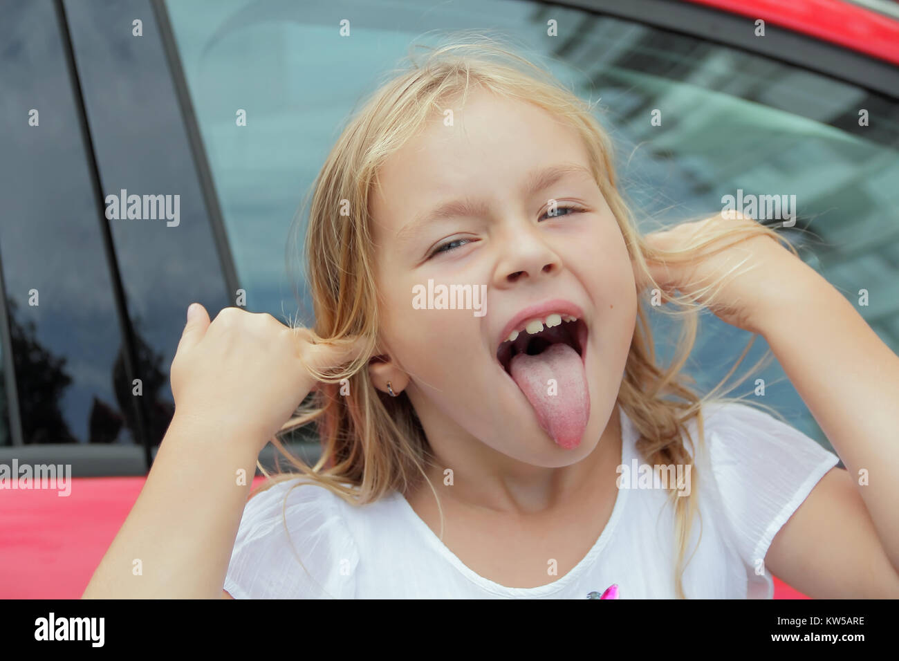 Portrait of girl with smile and makes faces Stock Photo - Alamy