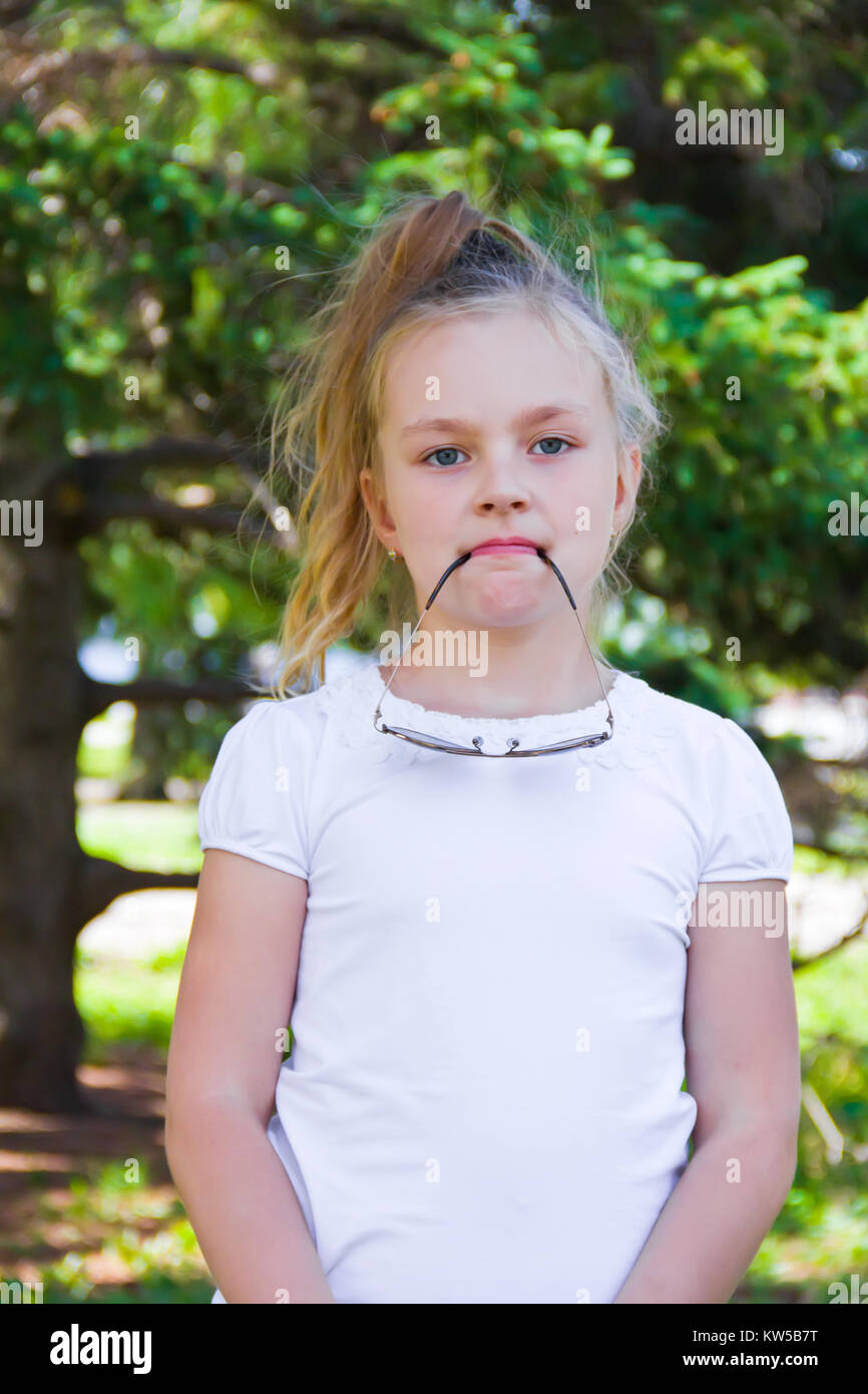 Cute girl playing with sunglasses in summer Stock Photo - Alamy