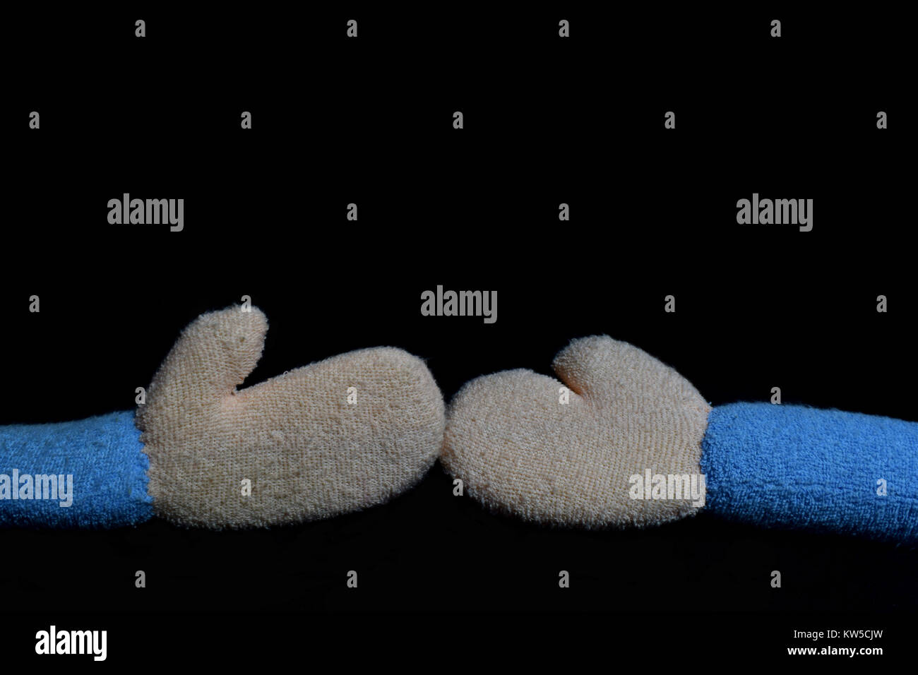 puppet hands brought together on black background Stock Photo - Alamy