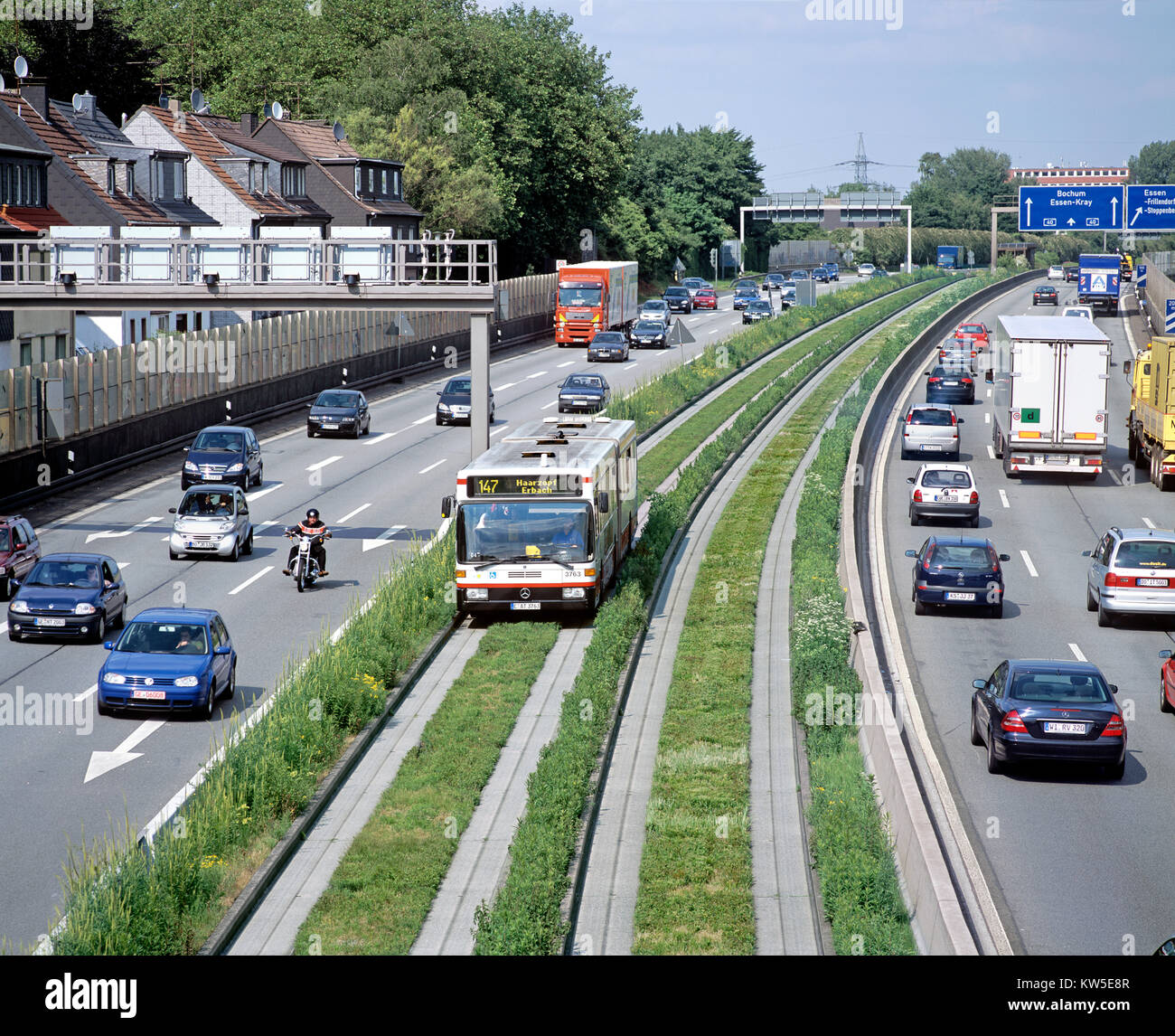 An O-Bahn "guided bus" in its concrete guideway in the middle of a dual ...
