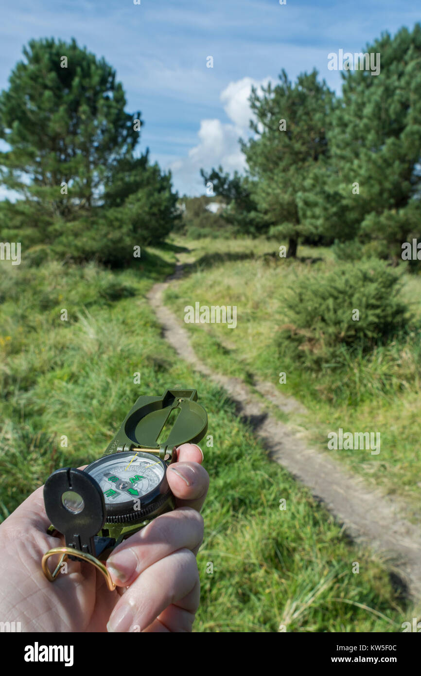 Lensatic compass in hand - for business 'direction', navigation, moral ...