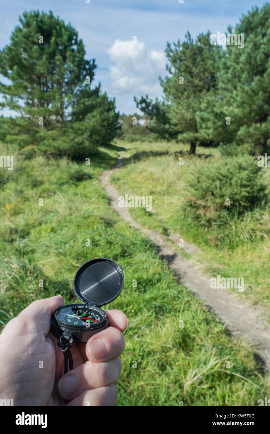 Lensatic compass in hand - for business 'direction', navigation, moral ...