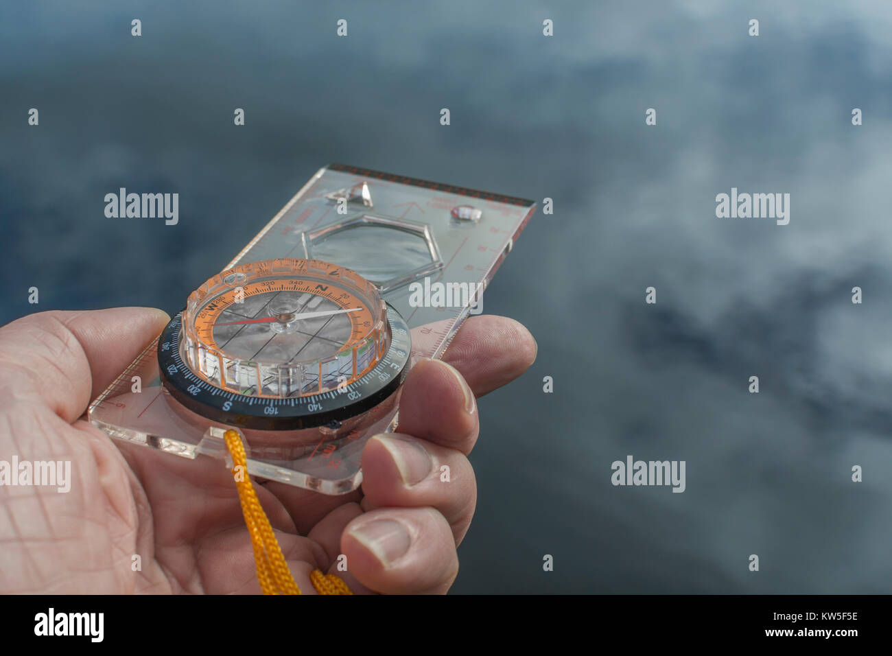 Orienteering compass in hand - for business 'direction', navigation ...