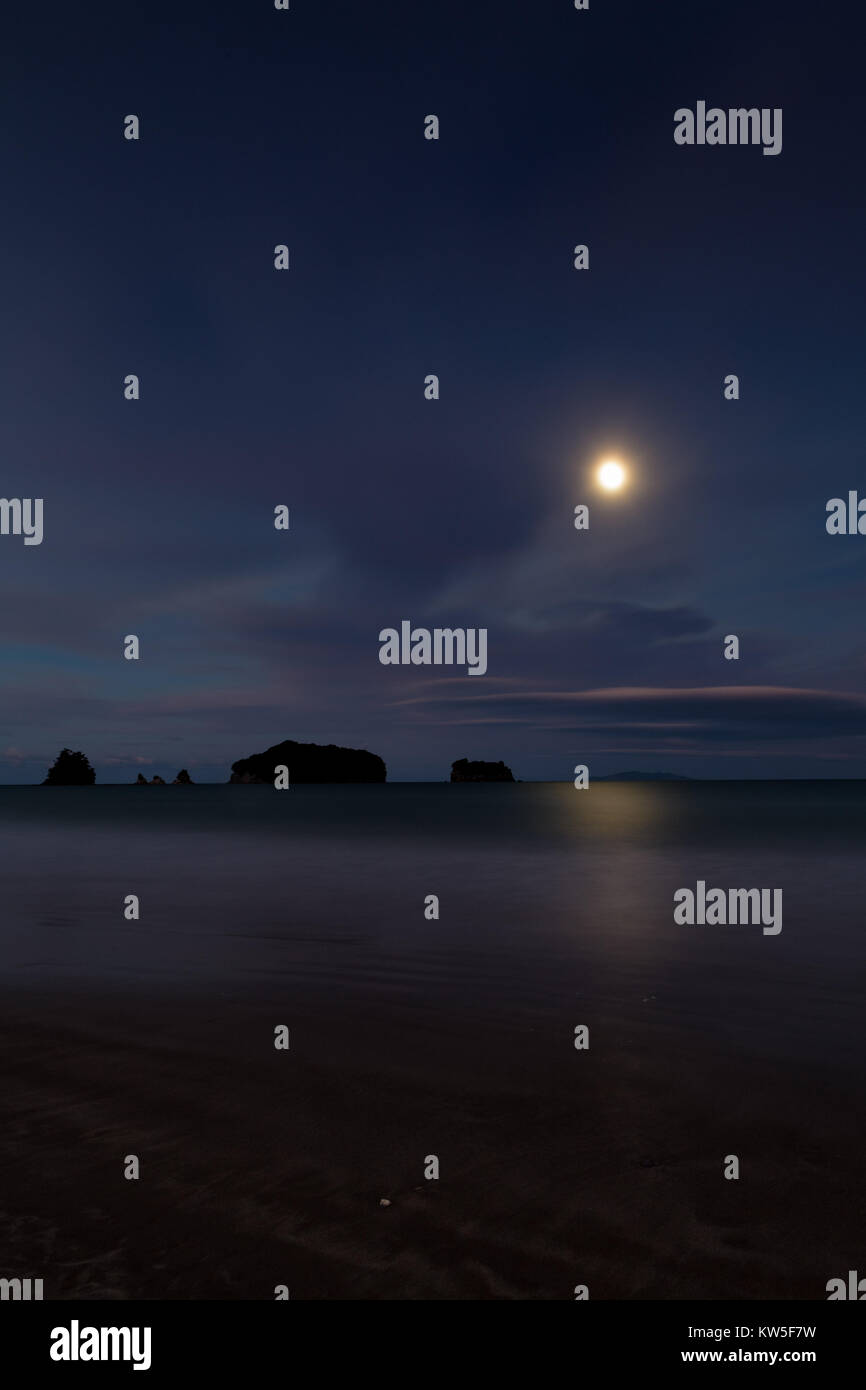 Moonrise over the beach and islands offshore at Whangamata, North ...
