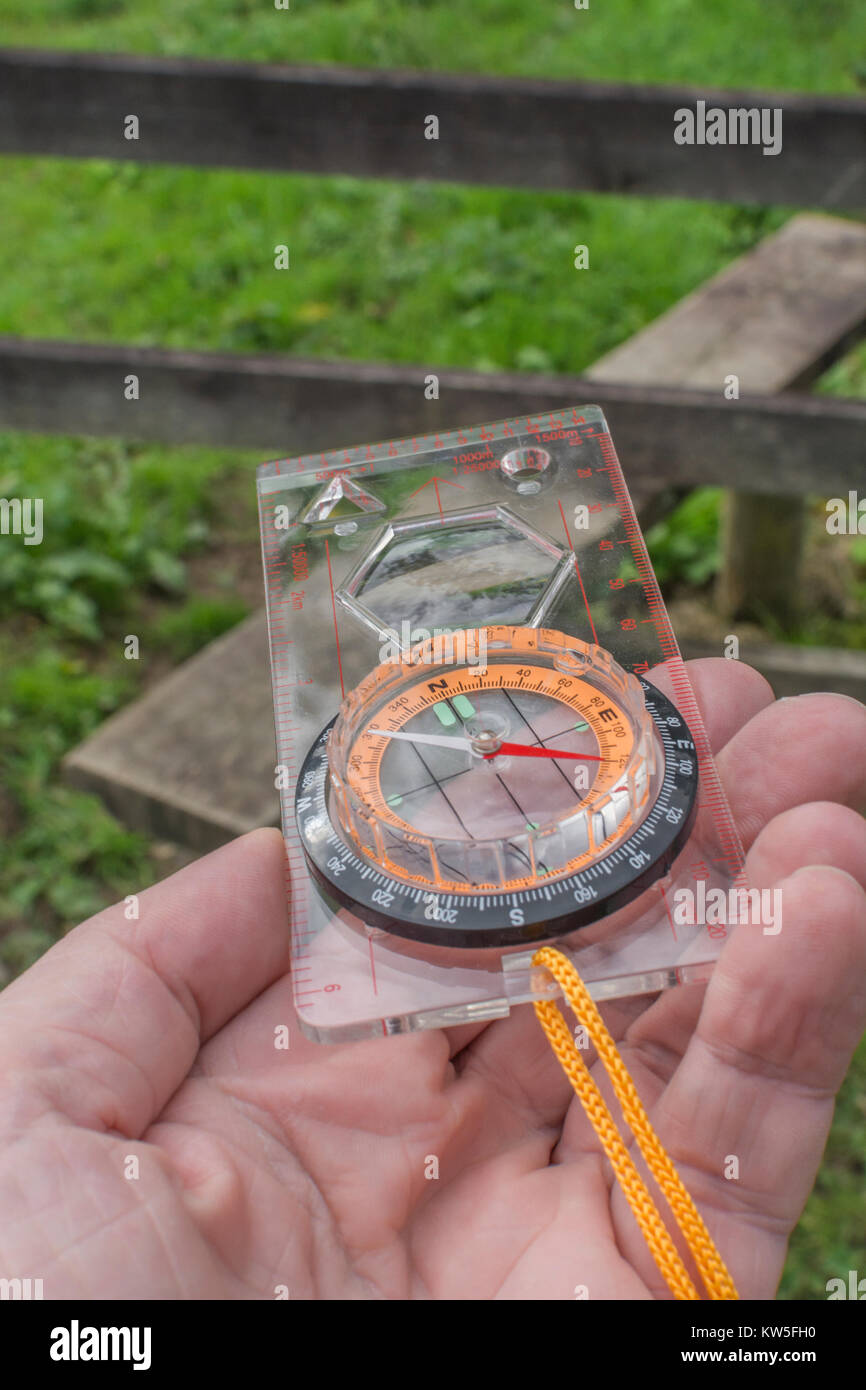Orienteering compass in hand - for business direction, navigation ...