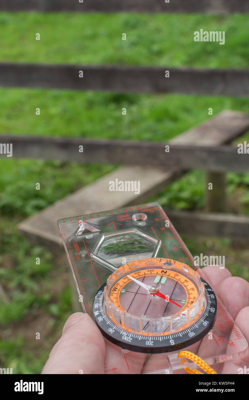 Orienteering compass in hand - for business 'direction', navigation ...