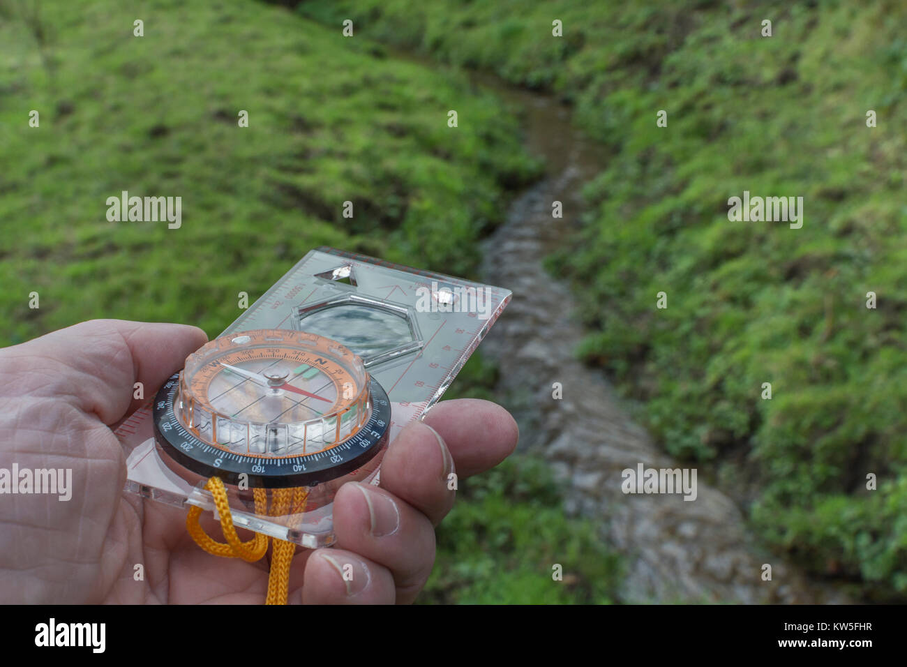 Orienteering compass in hand pointing East. For business 'direction ...