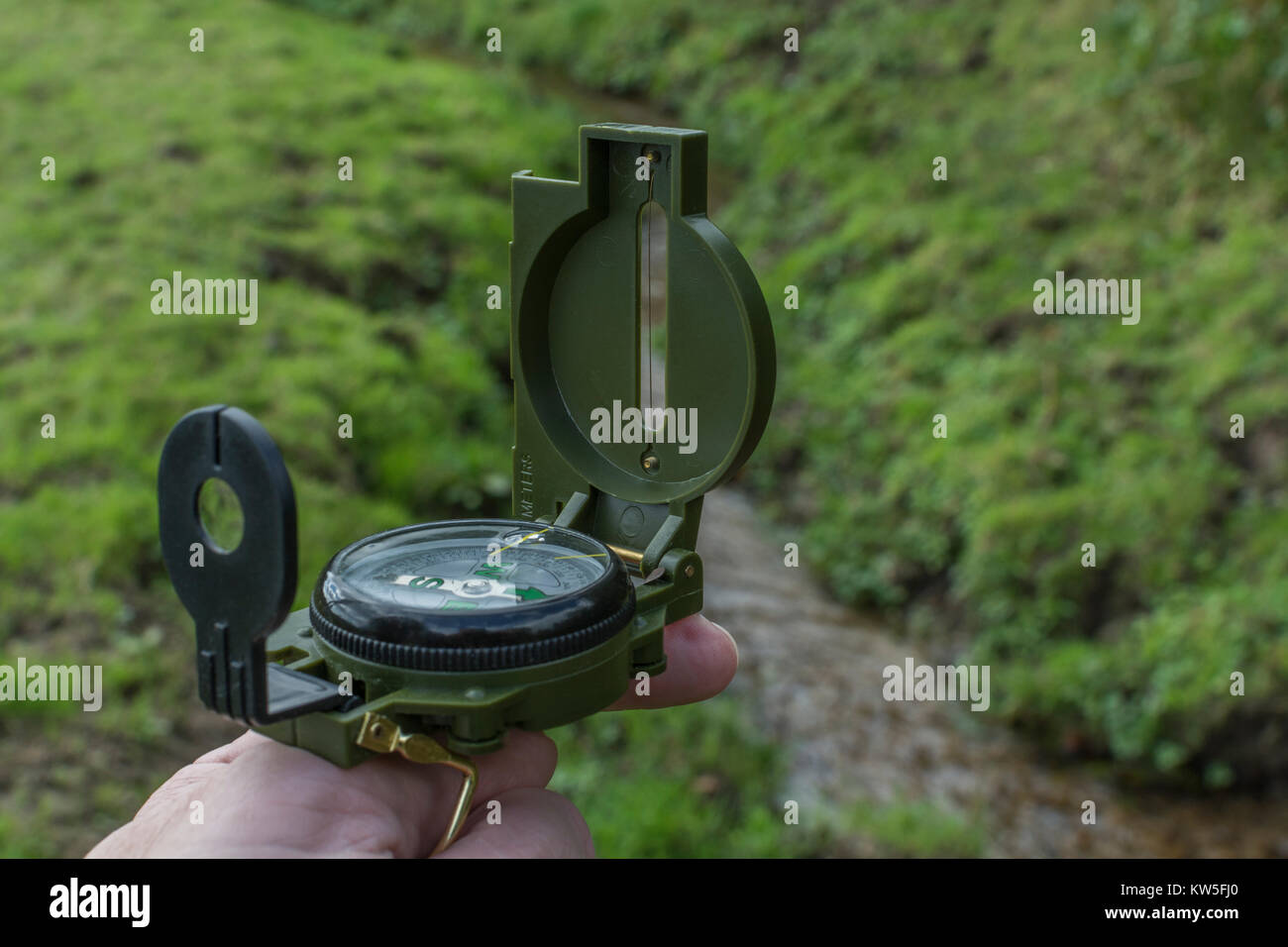 Lensatic compass in hand - for business 'direction', navigation, moral ...