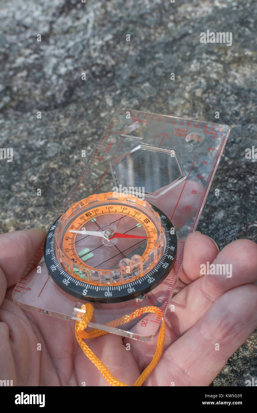 Orienteering compass in hand pointing SW - for business 'direction ...