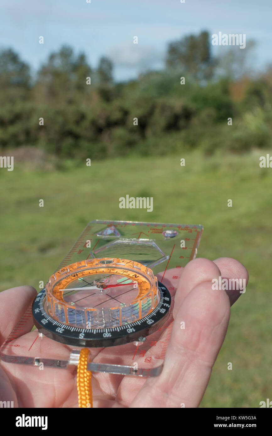 Orienteering Compass In Hand Pointing Ne For Business Direction Navigation Moral Compass