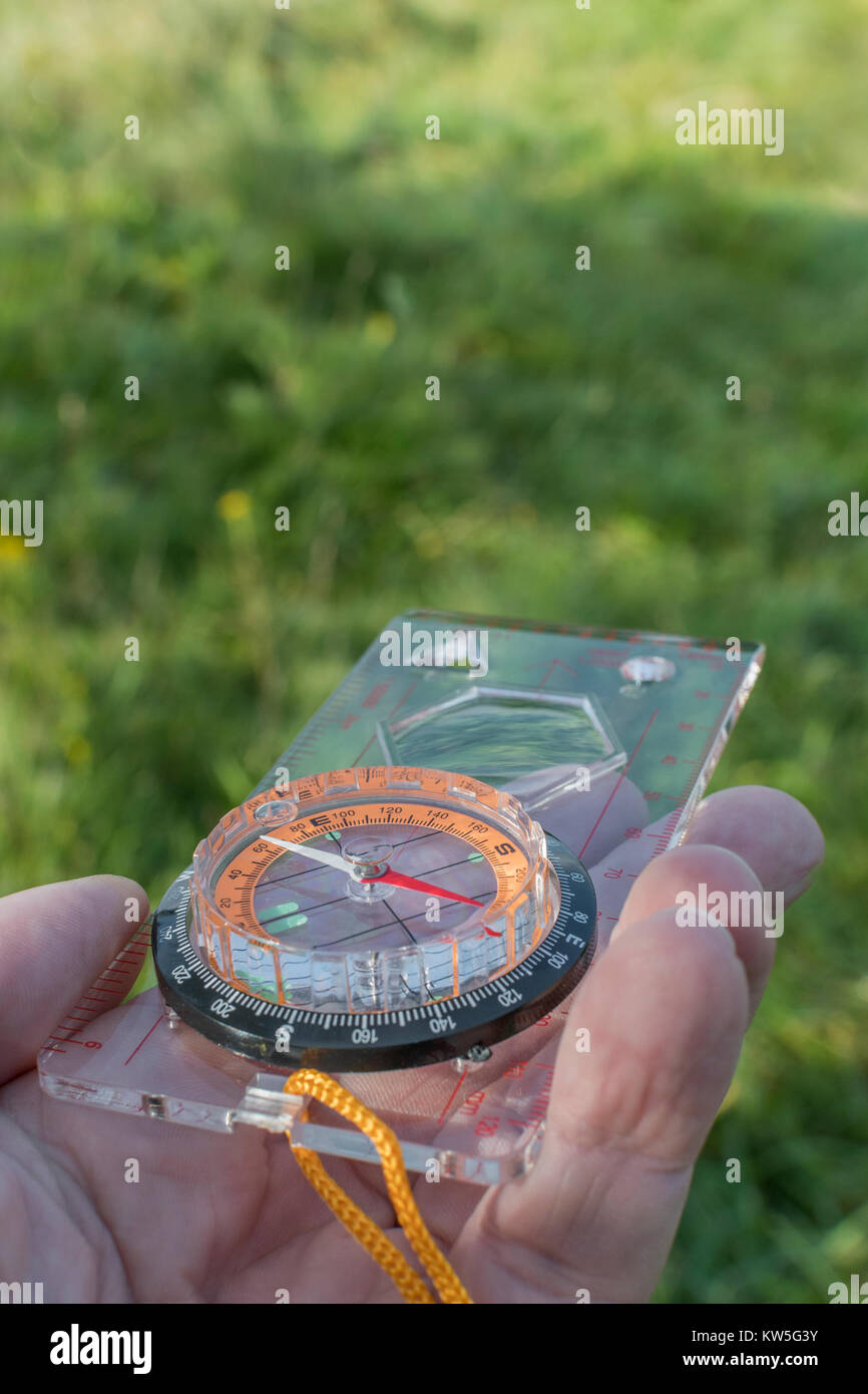 Orienteering compass in hand - for business 'direction', navigation ...