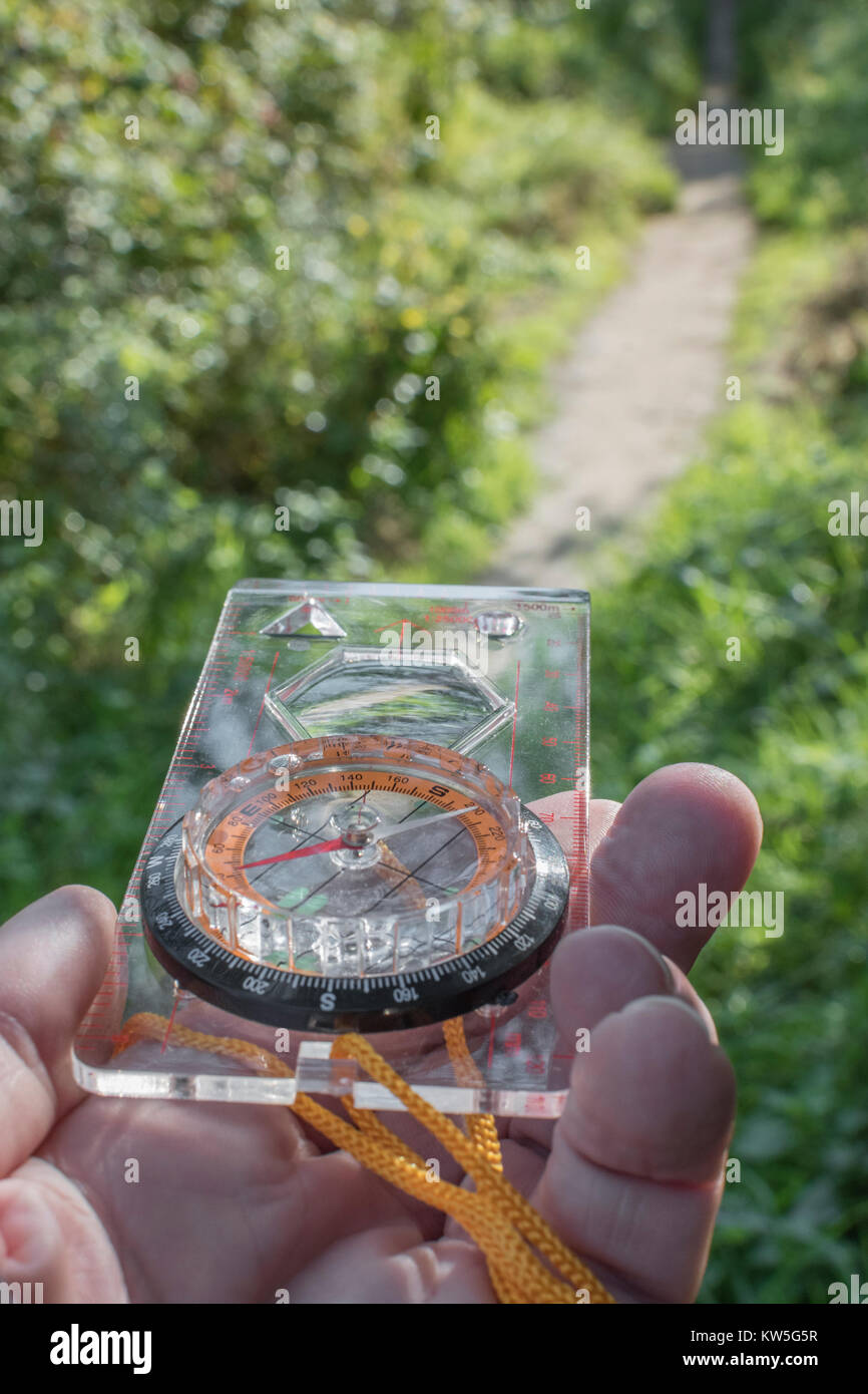 Orienteering compass in hand - for business 'direction', navigation ...