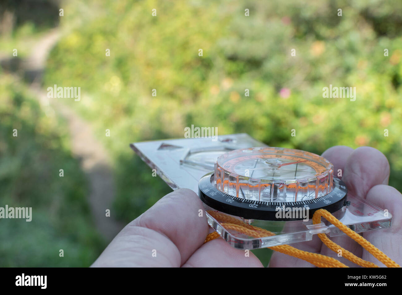 Orienteering compass in hand - for business 'direction', navigation ...