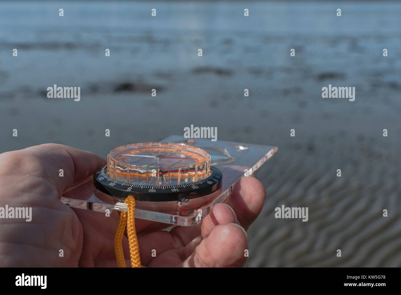 Orienteering compass in hand - for business 'direction', navigation ...