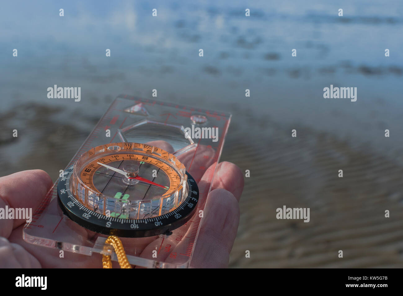 Orienteering compass in hand - for business 'direction', navigation ...