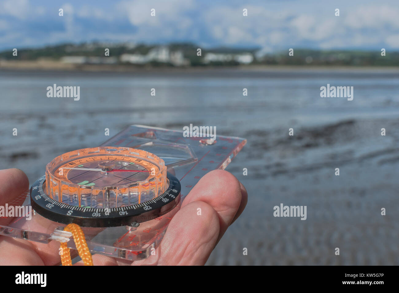 Orienteering compass in hand pointing SW. For business 'direction ...