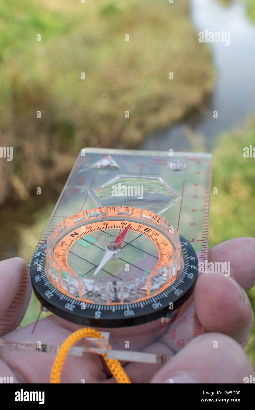 Orienteering Compass In Hand Pointing Ne For Business Direction Navigation Moral Compass